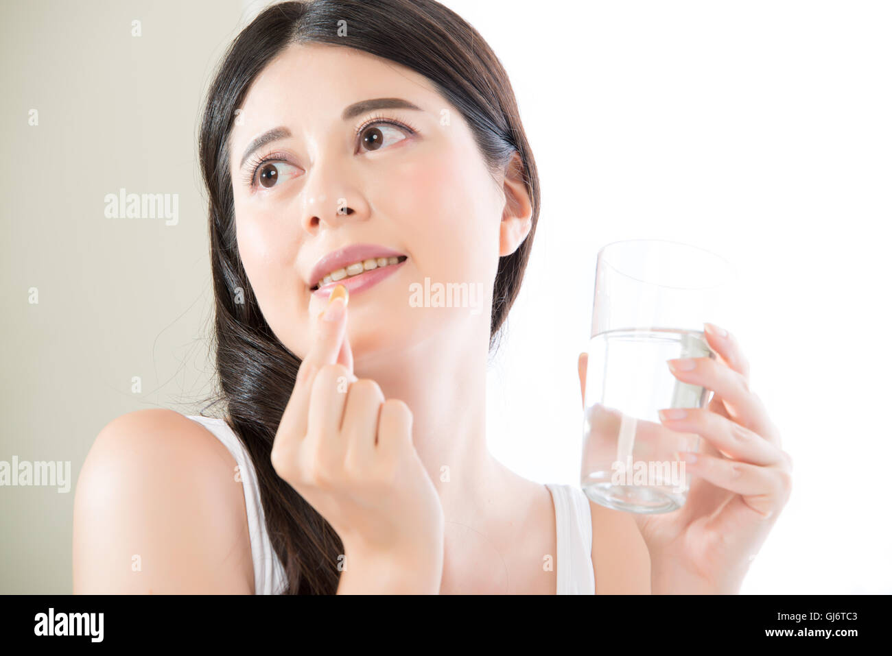 beautiful asian women eating nutritional vitamin supplement for healthy ...