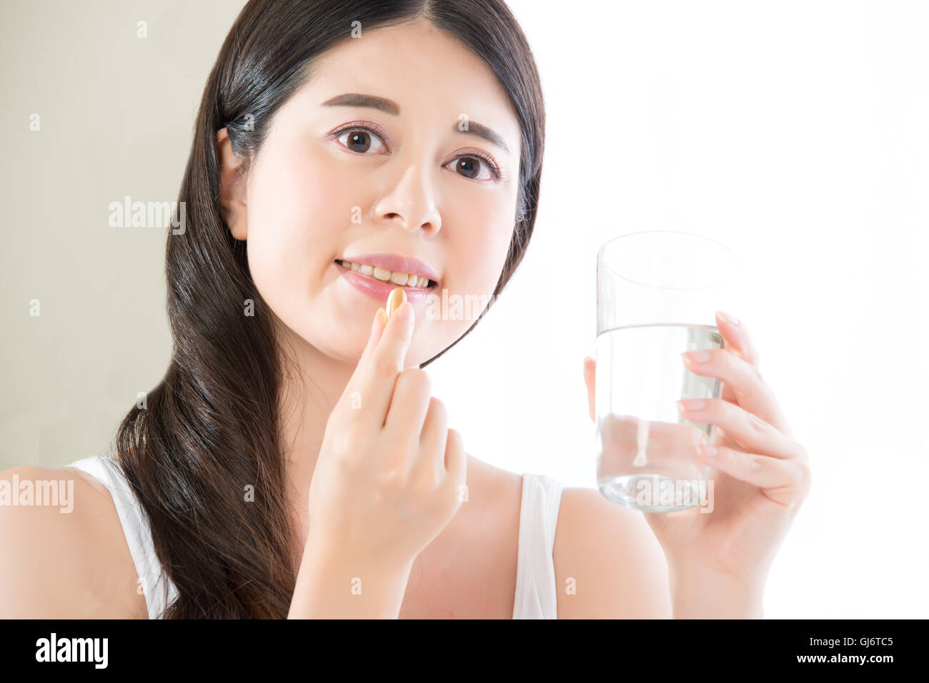 smile asian women eating nutritional fish oil supplement for healthy ...