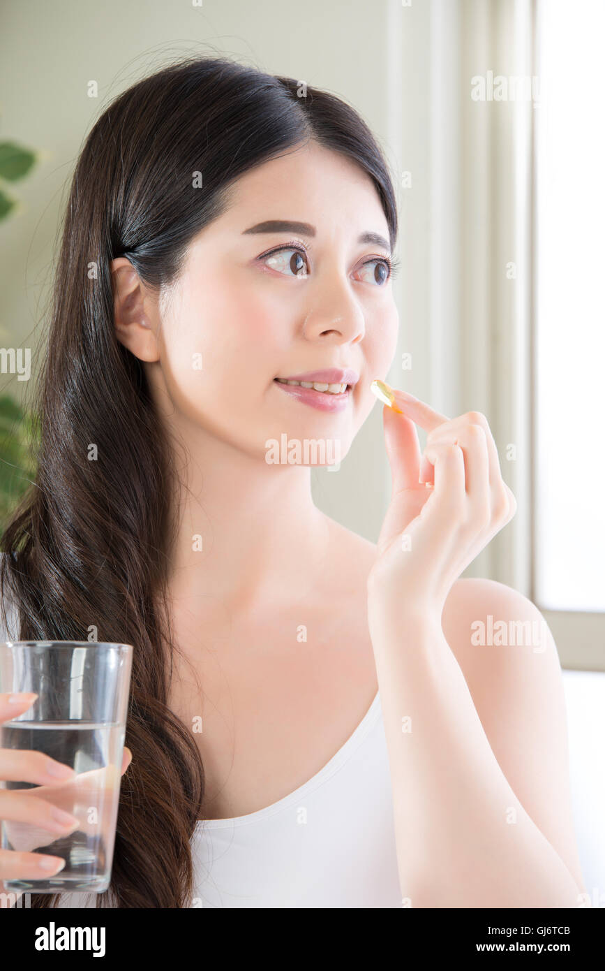 smile beautiful asian women eating nutritional vitamin supplement for ...