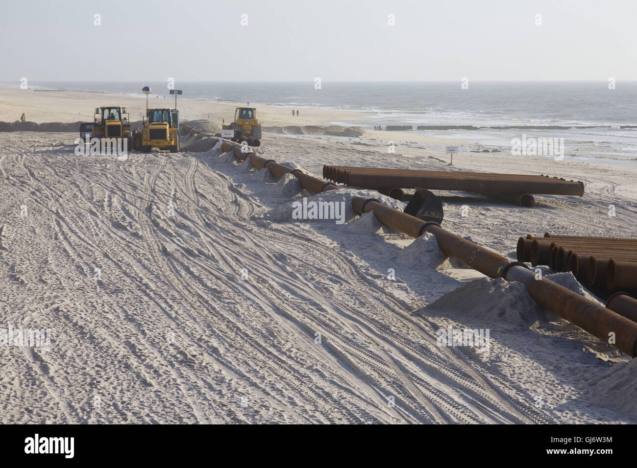 Sand replenishment at the red cliff Stock Photo - Alamy