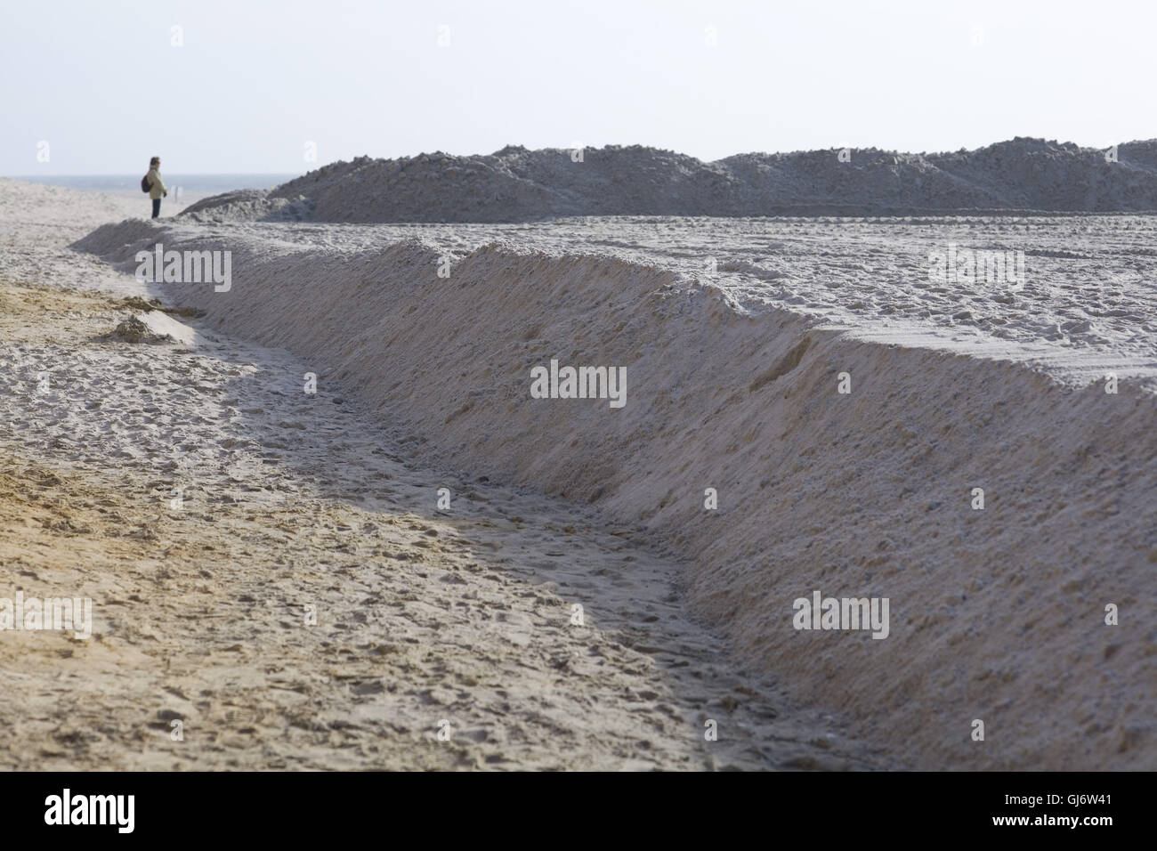 Sand replenishment at the red cliff Stock Photo - Alamy