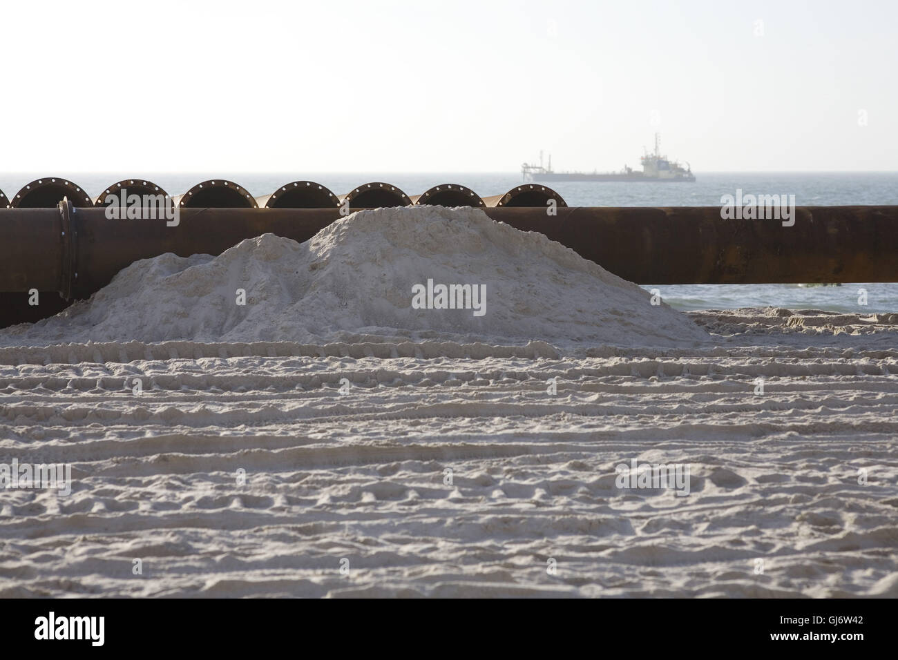 Sand replenishment at the red cliff Stock Photo - Alamy