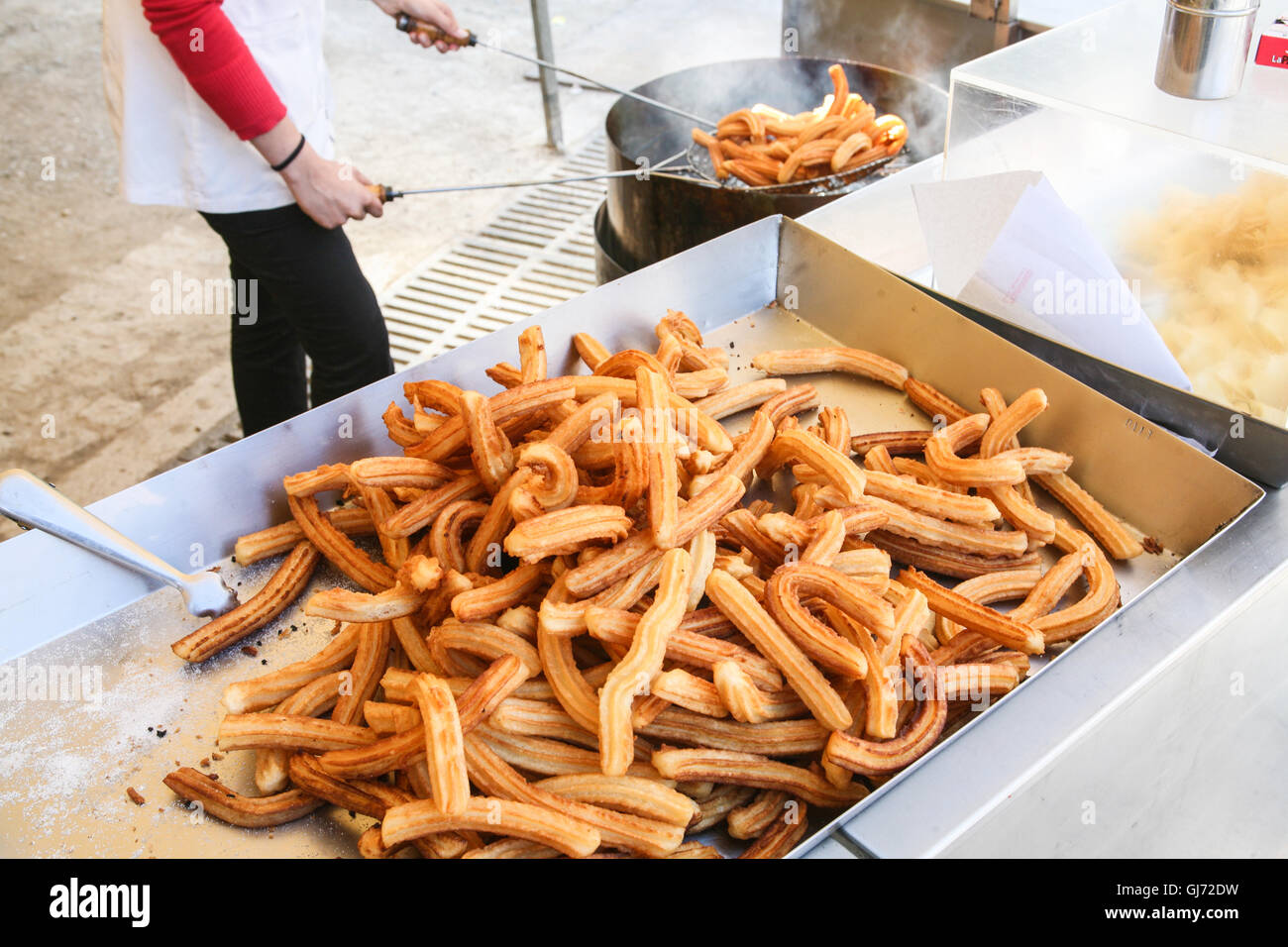 Frying churros, a very popular Spanish snack,typically crunchy outside ...