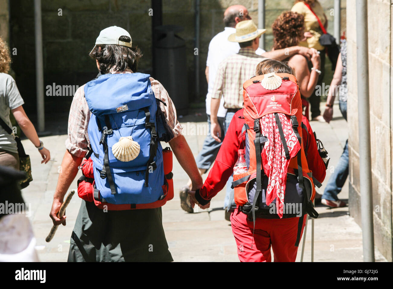 Pilgrims, with shells, the symbol of the pilgrimage, on their backpacks ...