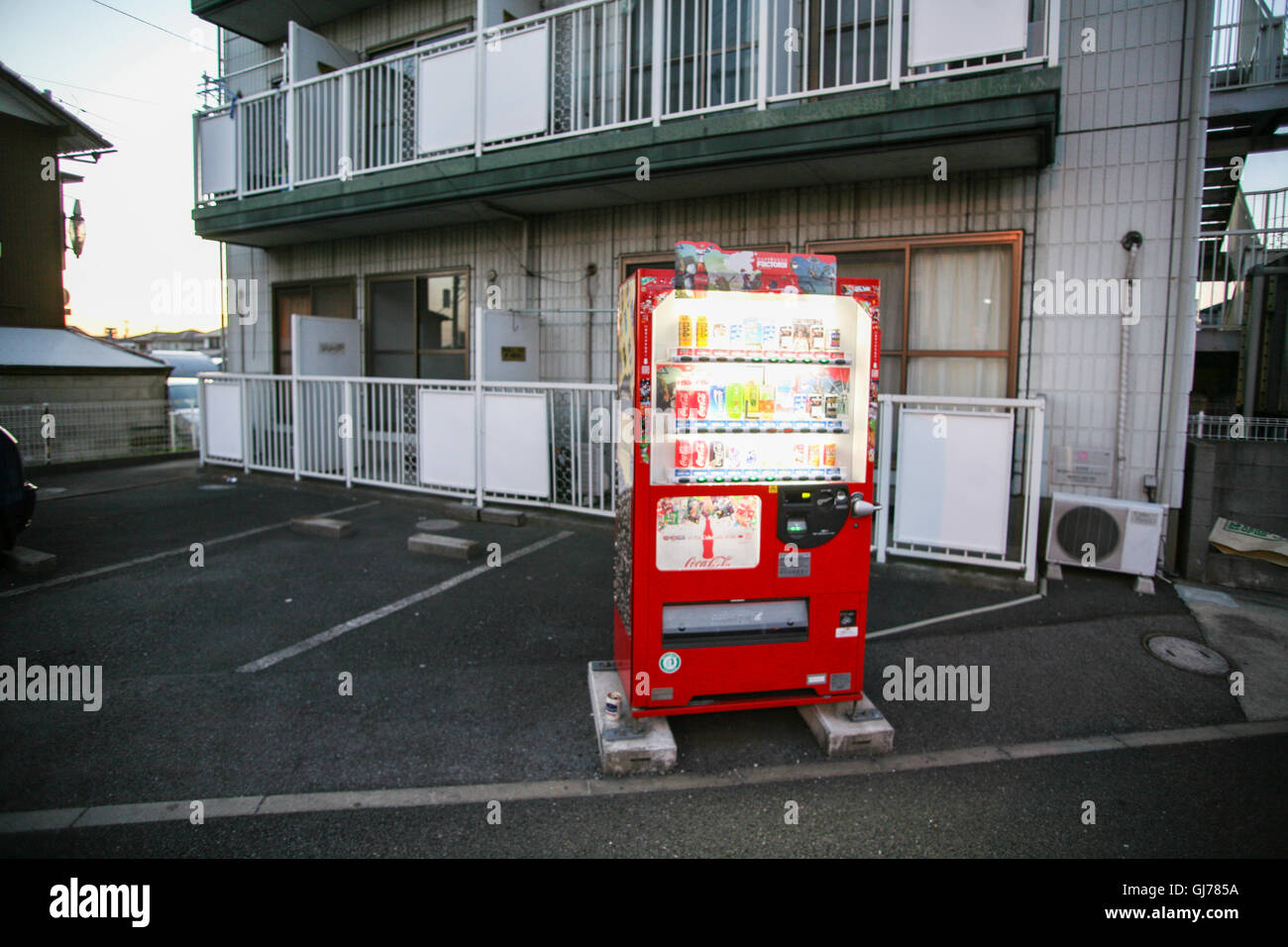 In front of this apartment bulding a sole vending machine that glows as ...