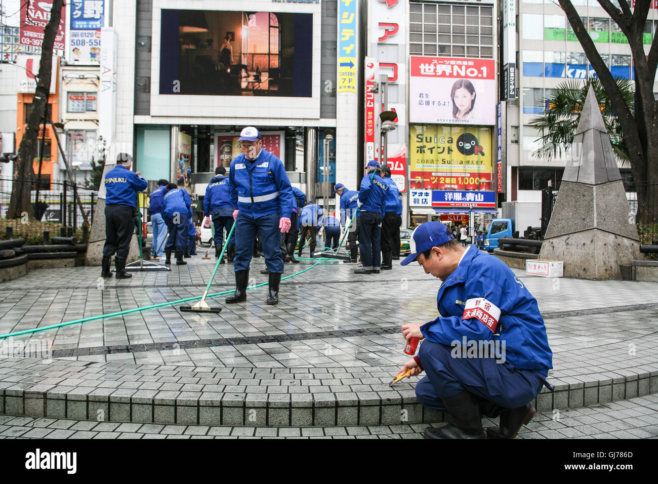 Cleaning the area around Shinjuku Station. Here at East Exit of ...