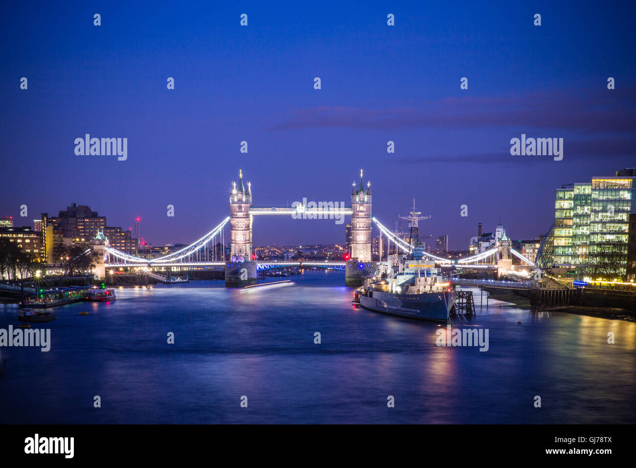 Nightime, long exposure of Tower Bridge and the river Thames with HMS Belfast, London, UK Stock ...