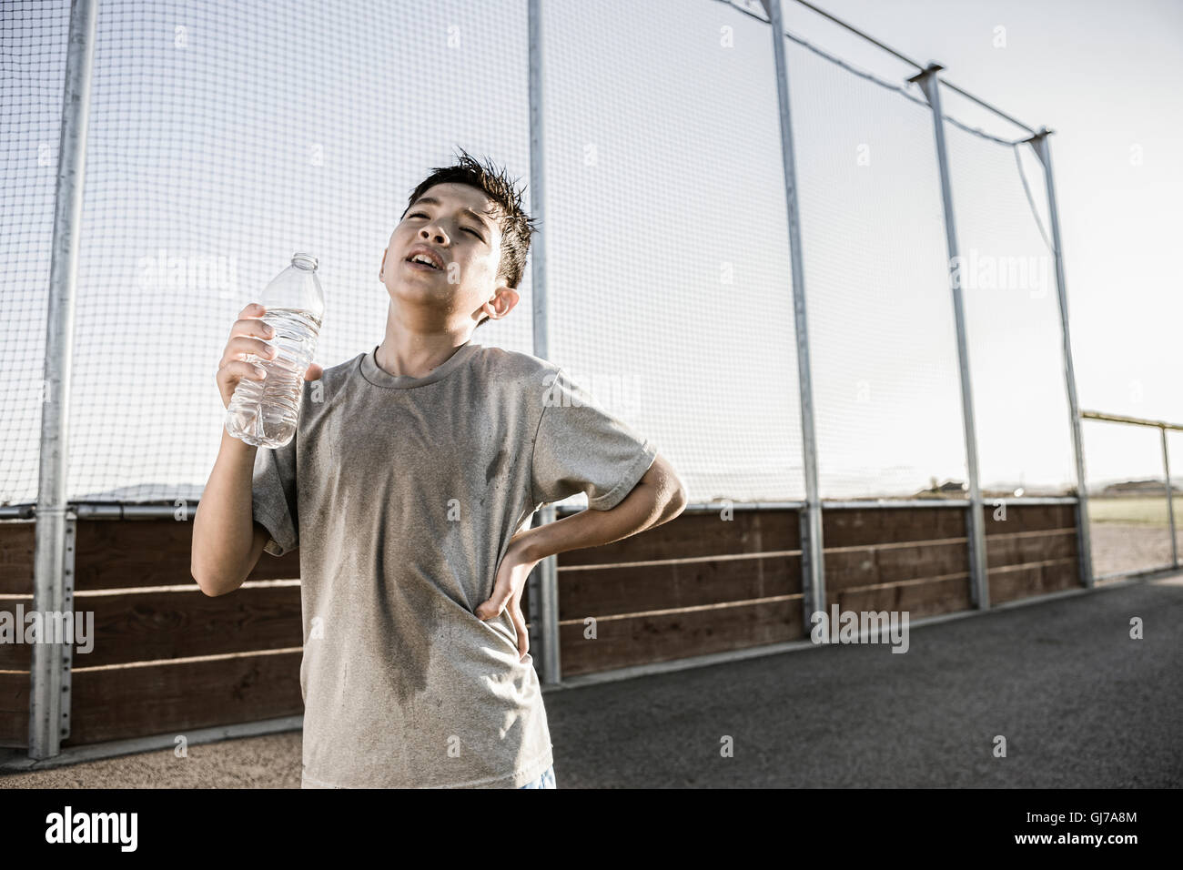 A young boy shows how tired he is after a hard practice Stock Photo - Alamy