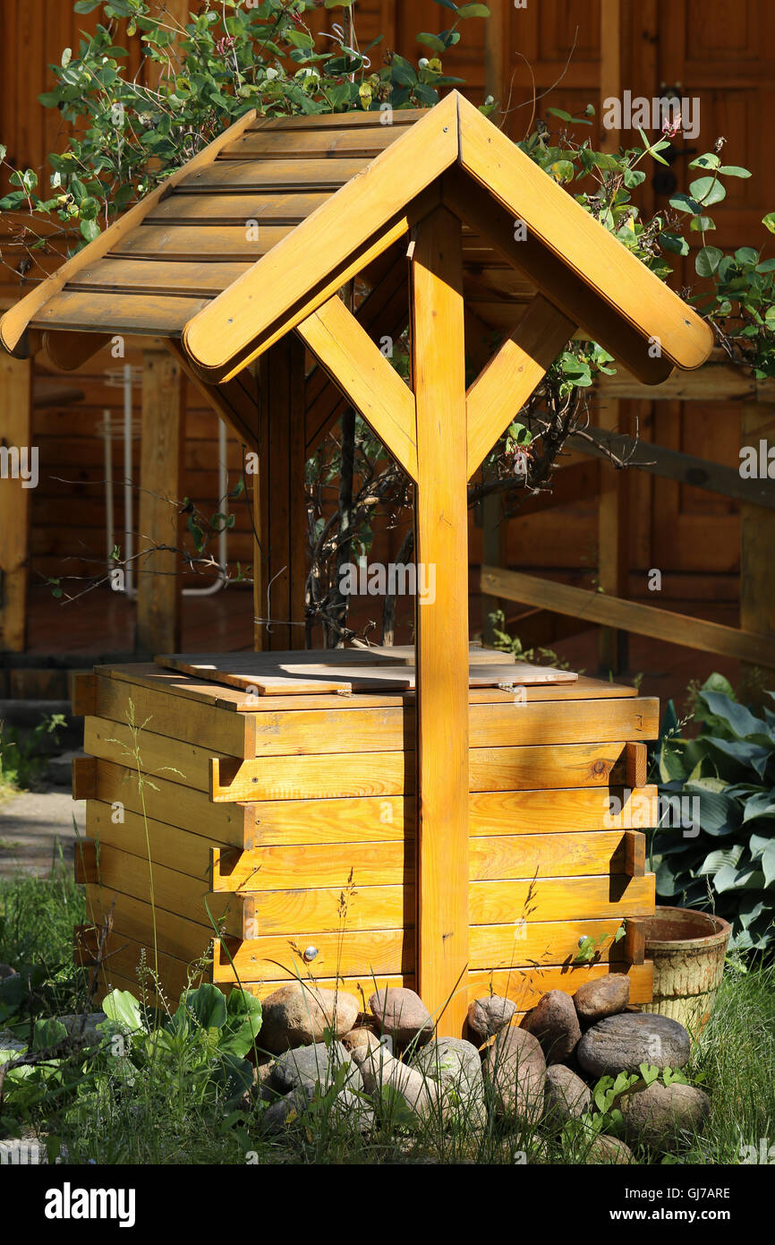 Wooden water well in the home garden Stock Photo - Alamy