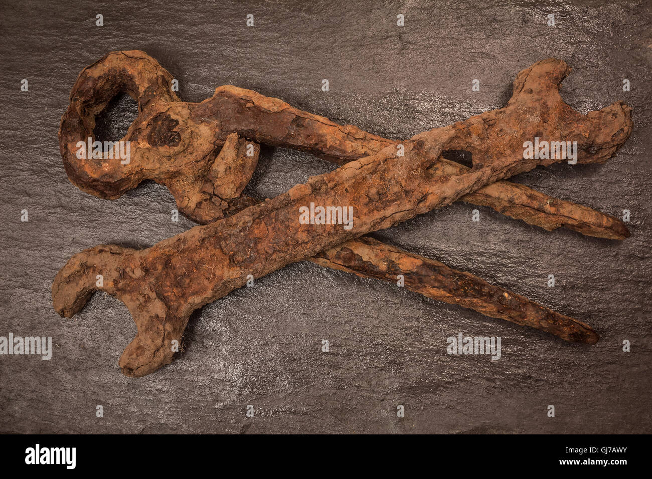 rusted tools on a slate background Stock Photo - Alamy