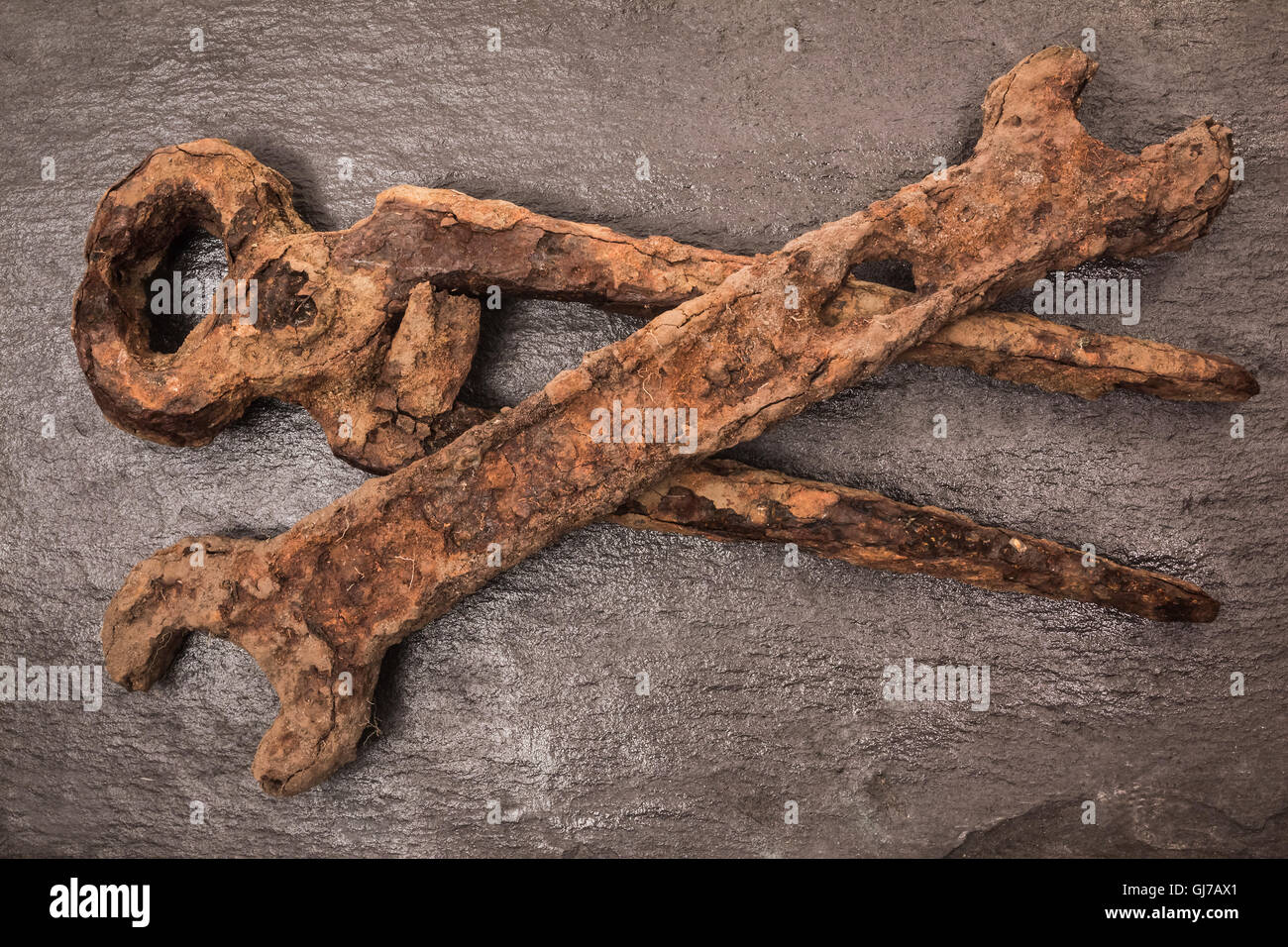 rusted tools on a slate background Stock Photo - Alamy
