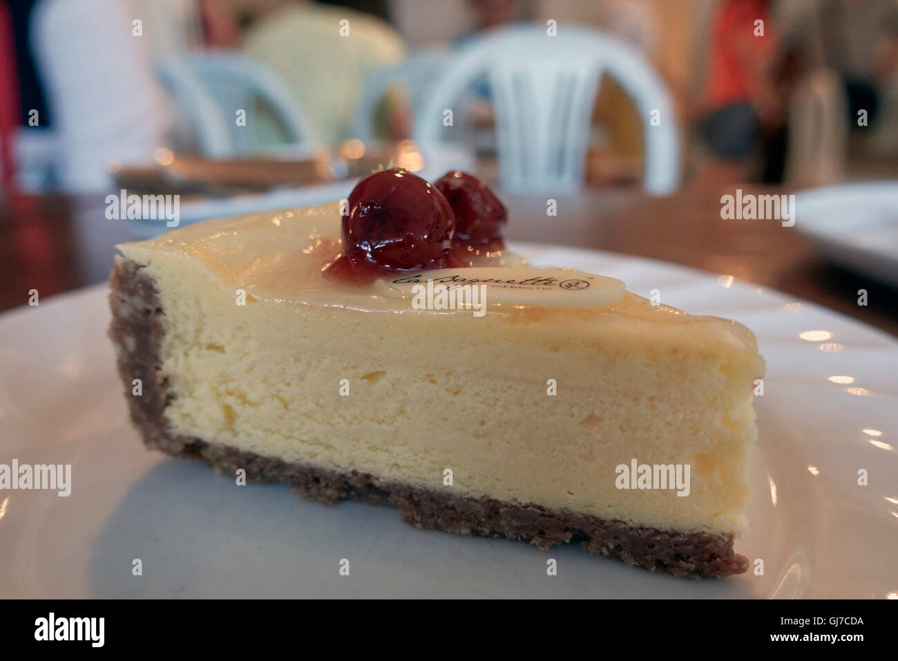 Fancy cakes. Slice of sponge cake with cherry topping Stock Photo - Alamy