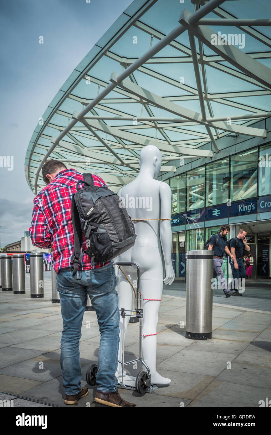 London, England, UK: A rail passenger arriving at King's Cross railway ...