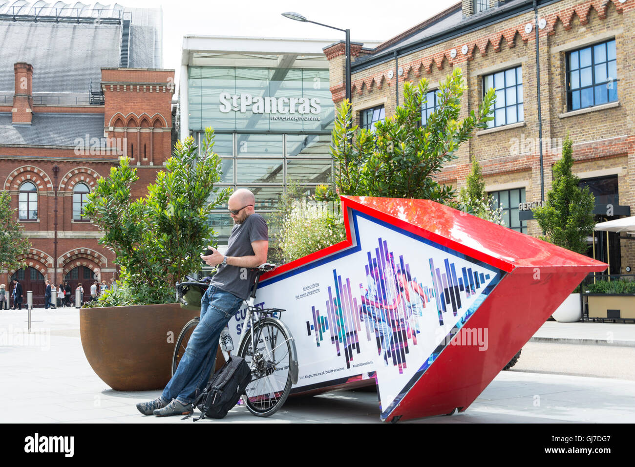 A man resting outside Kings Cross Station in King's Cross Square ...
