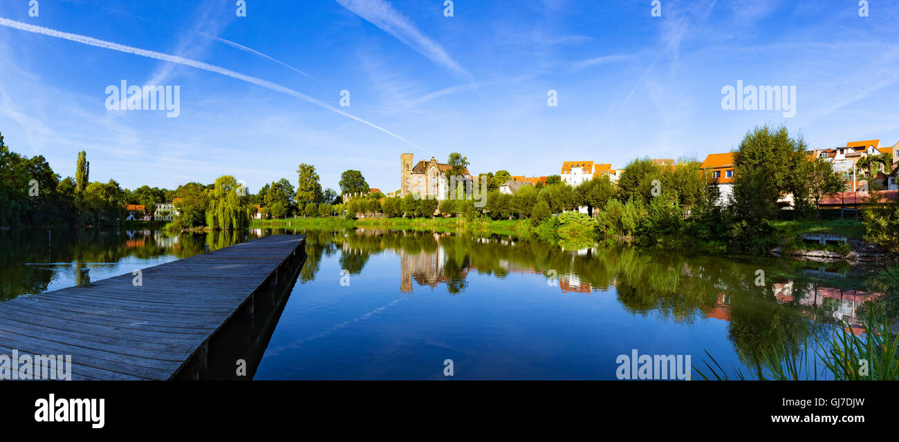 Pond in village with houses reflection in germany Stock Photo - Alamy