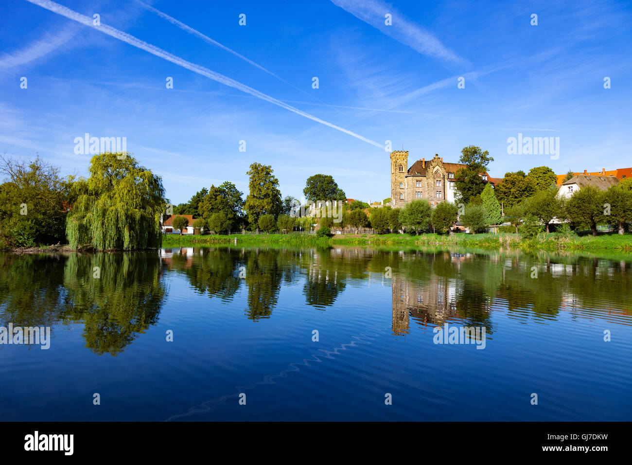 Pond in village with houses reflection in germany Stock Photo - Alamy