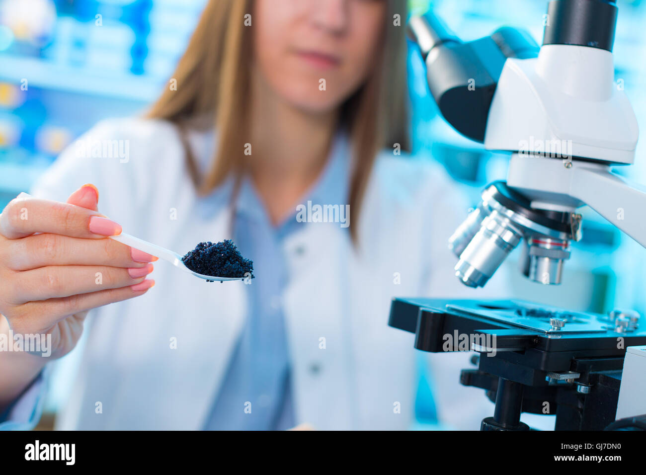 Quality control of food products. Young woman in chemical laboratory ...