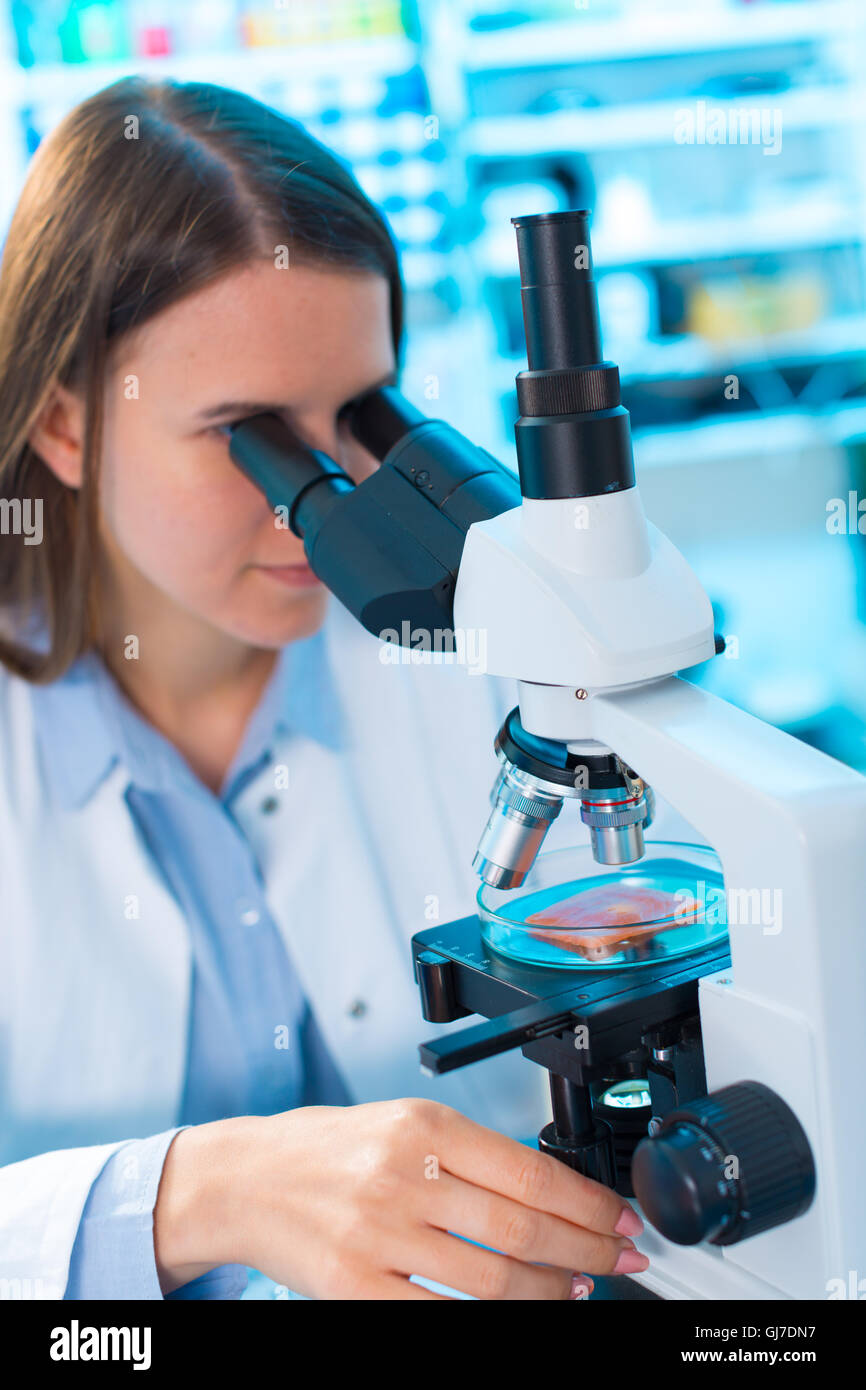 Quality control of food products. Young woman in chemical laboratory ...