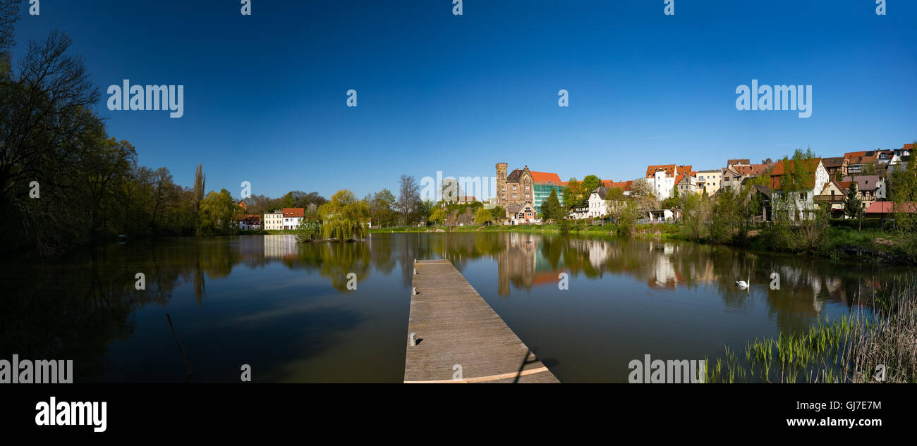 Pond in village with houses reflection in Germany Stock Photo - Alamy