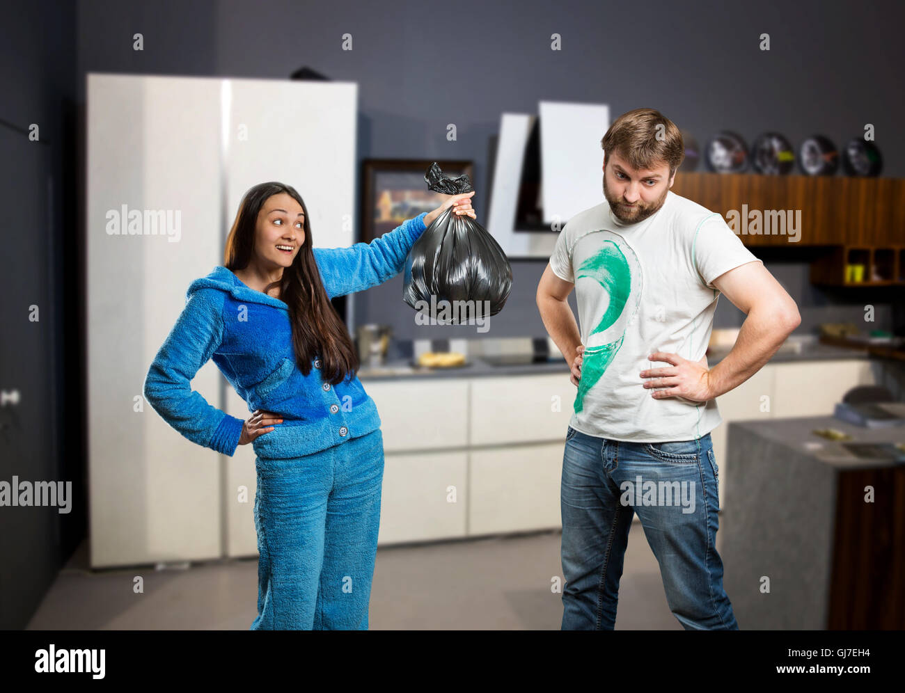Wife asking her husband to take out the trash Stock Photo - Alamy