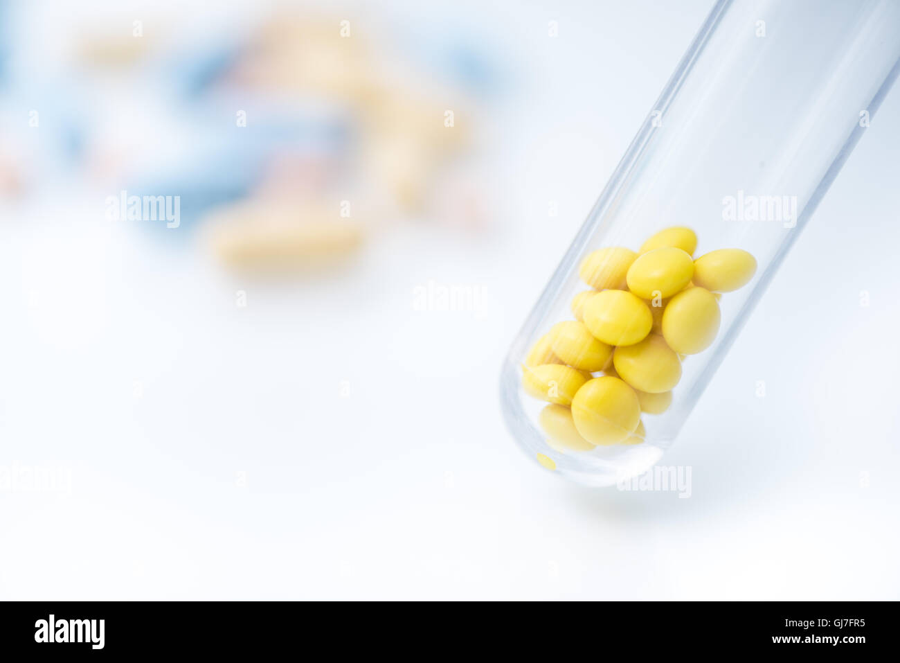 yellow pills or drugs, selective focus Stock Photo - Alamy