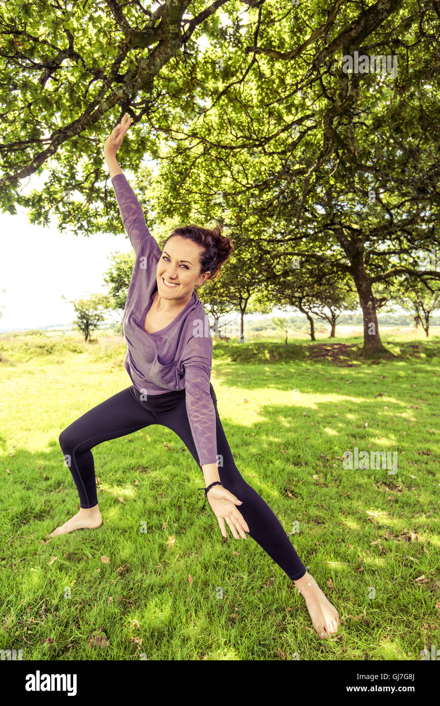 beautiful woman pose yoga in park under tree barefoot Stock Photo - Alamy