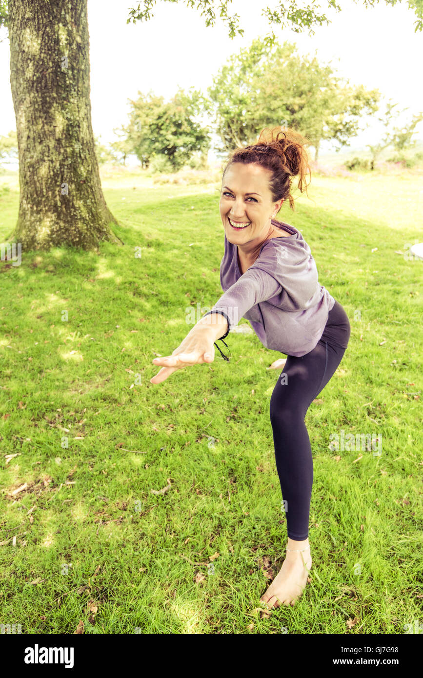 lady smilling while streching body in park barefoot Stock Photo - Alamy