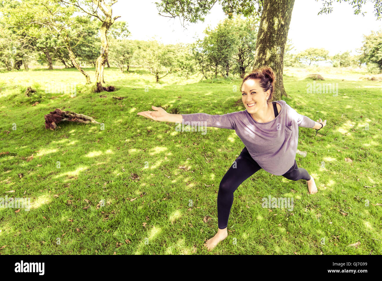 lady smilling while streching body in park barefoot Stock Photo - Alamy