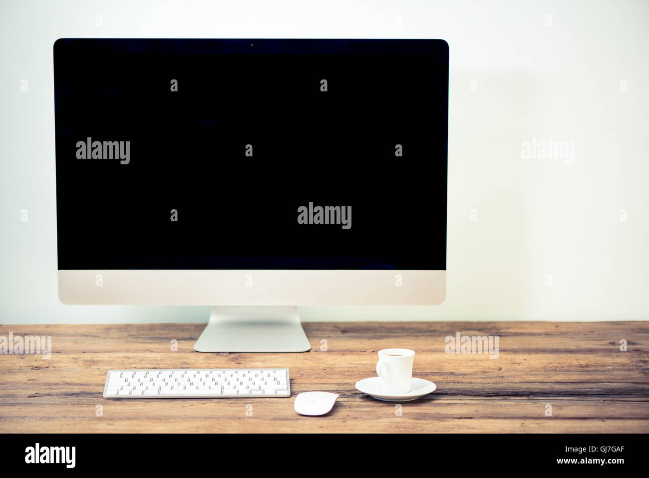 modern computer screen on desk and cup of coffee Stock Photo - Alamy