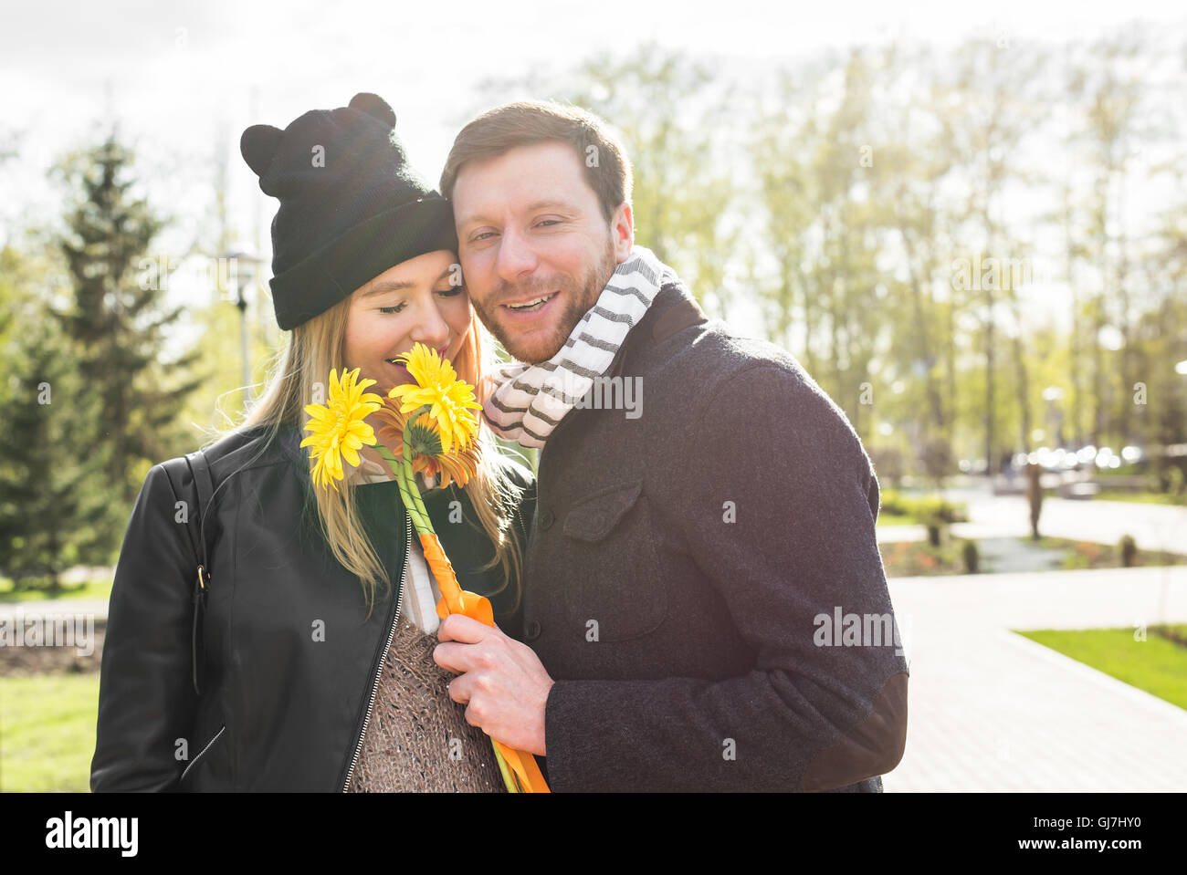 Couple with flower at park. Outdoor Stock Photo - Alamy
