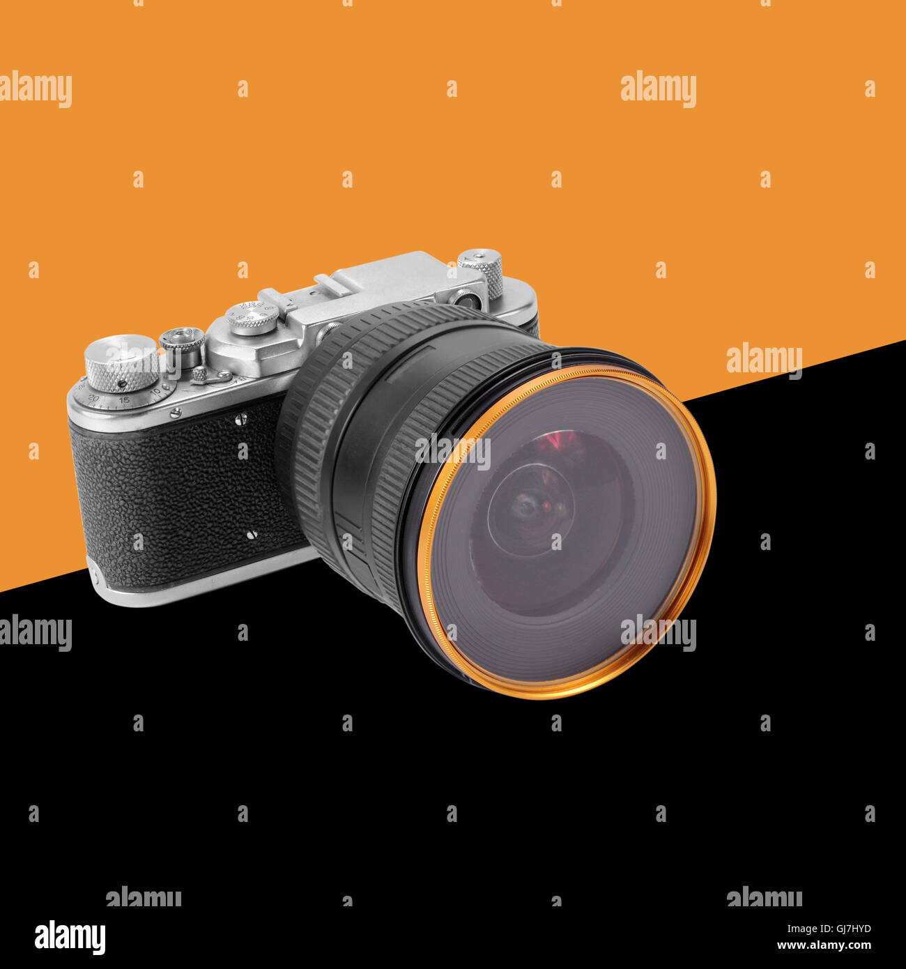 Old film camera on a orange and black background Stock Photo - Alamy