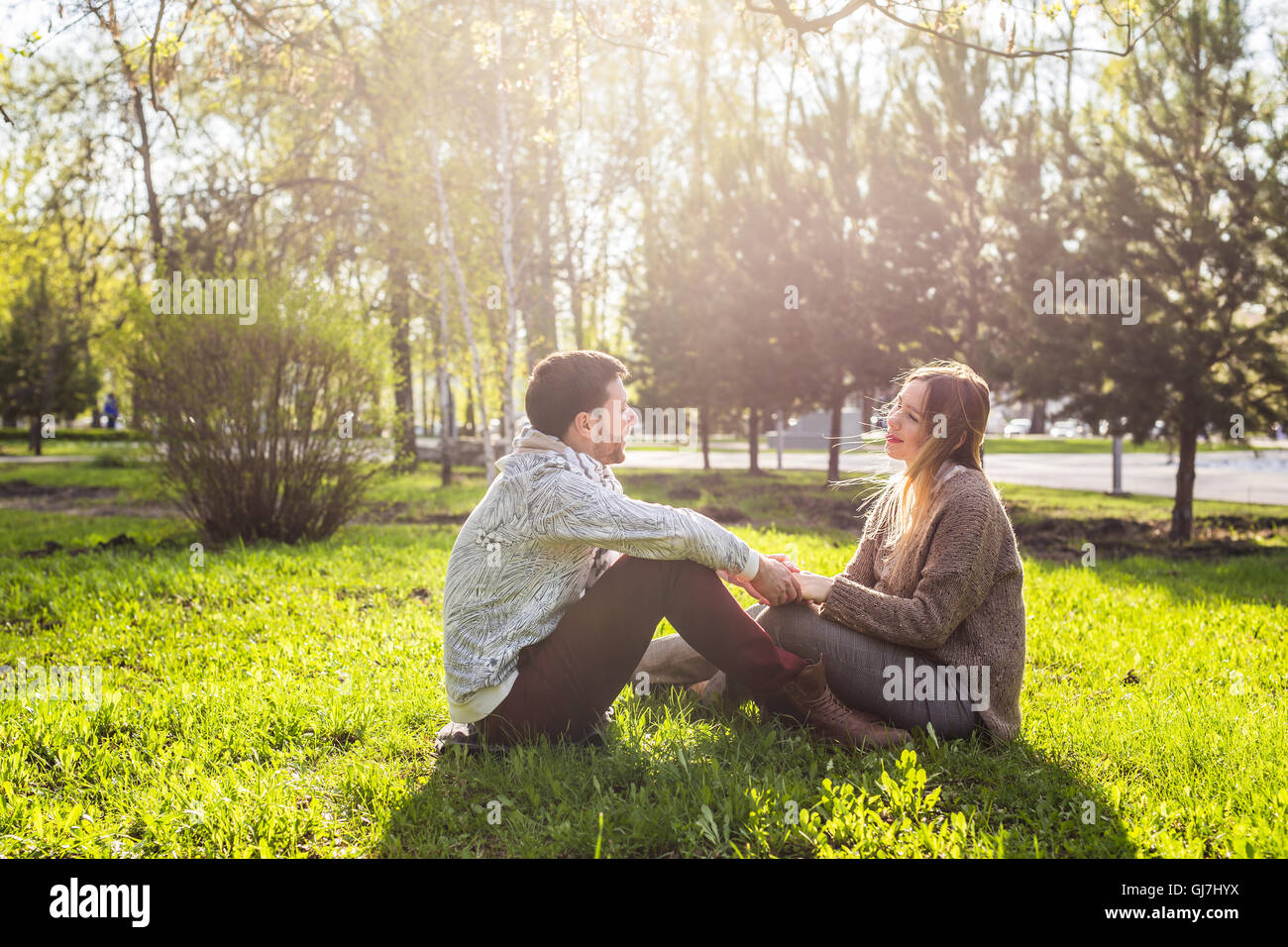 Romantic young couple in love relaxing outdoors in park Stock Photo - Alamy