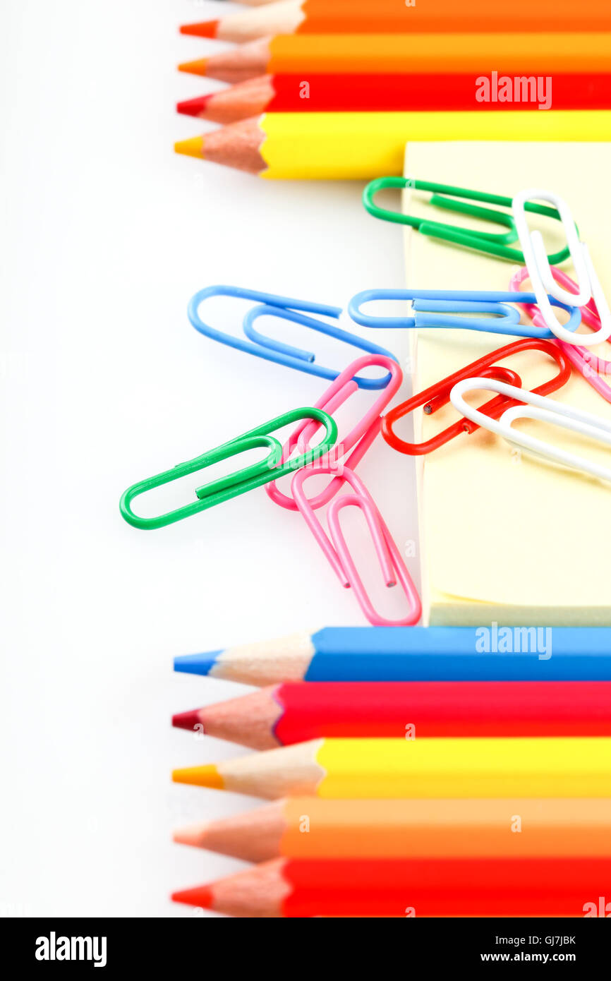 set of colored pencils and paper clips on a white background Stock ...