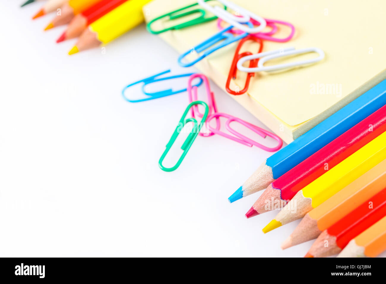 set of colored pencils and paper clips on a white background Stock ...
