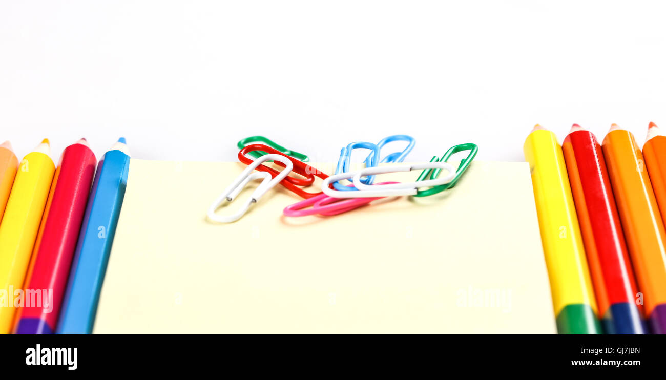 set of colored pencils and paper clips on a white background Stock ...