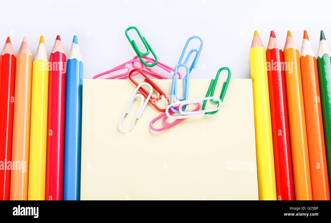 set of colored pencils and paper clips on a white background Stock ...