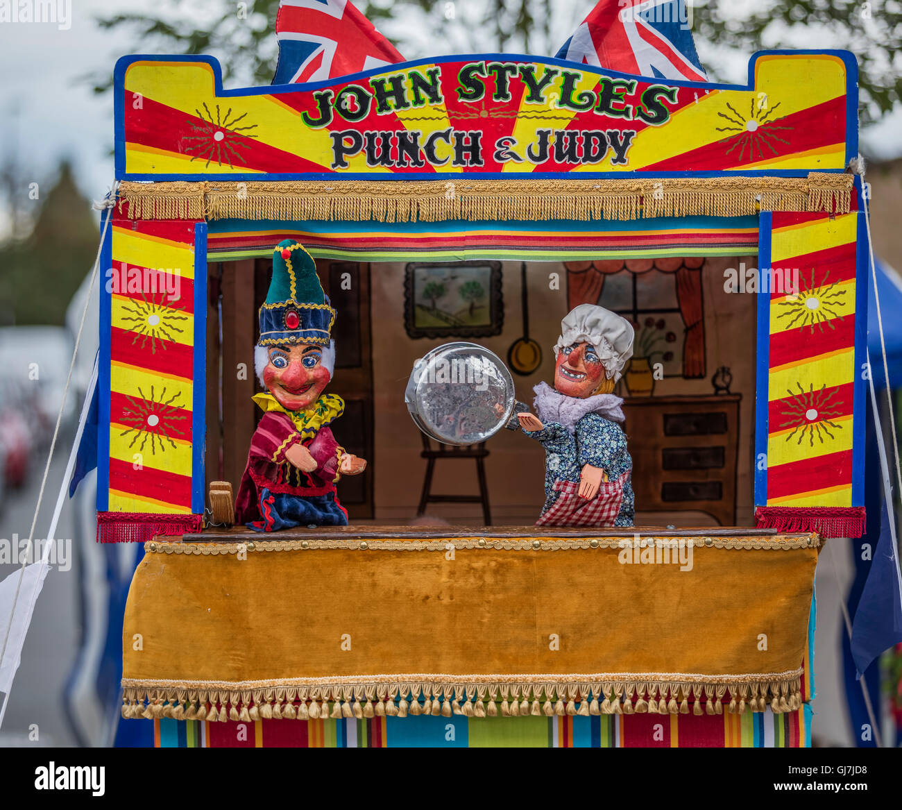 Mr Punch next to Judy holding a frying pan in a Punch and Judy puppet ...