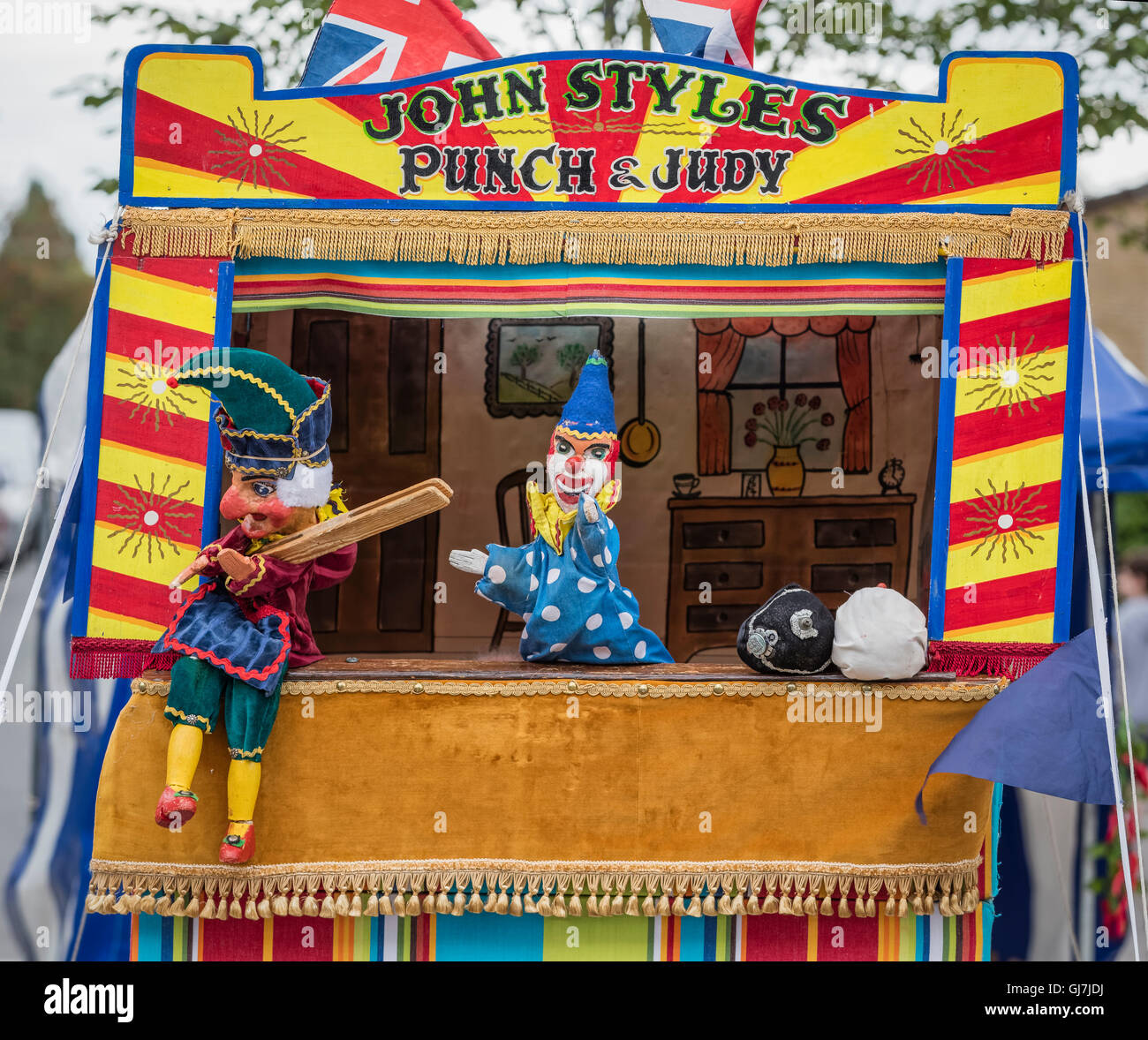 Mr Punch looks away from the Punch and Judy glove puppet booth with a ...