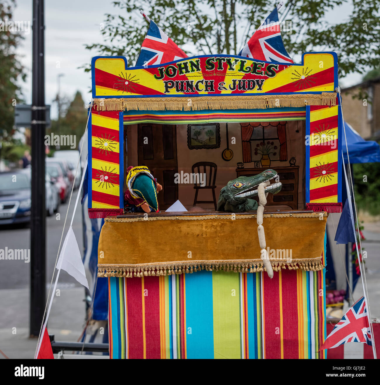 Mr Punch with his head down as the crocodile has sausages in his mouth ...