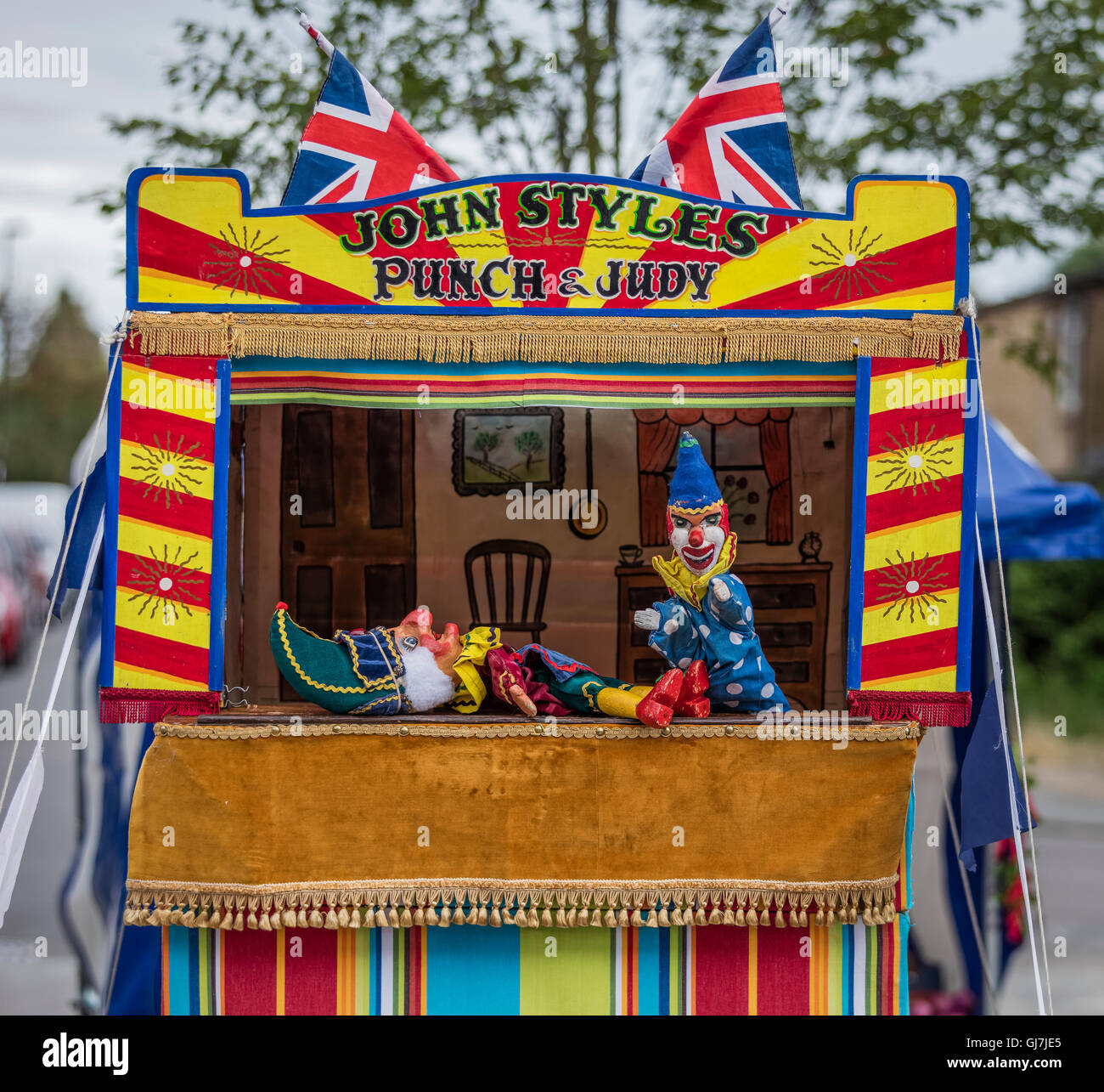 Mr Punch lying flat on his back with Joey The Clown at a punch and judy ...