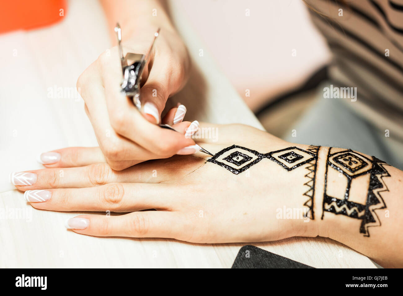 Drawing process of henna menhdi ornament on woman's hand Stock Photo ...