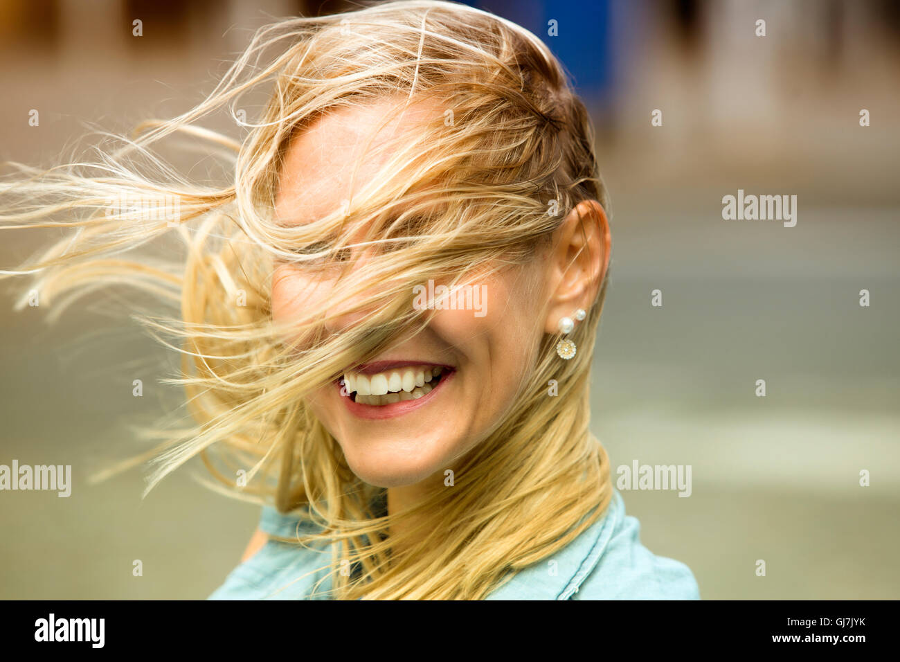 portrait of happy laughing blond woman with wind in her hair Stock ...
