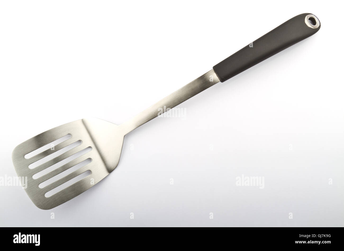 Stainless steel spatula on a plain background Stock Photo - Alamy