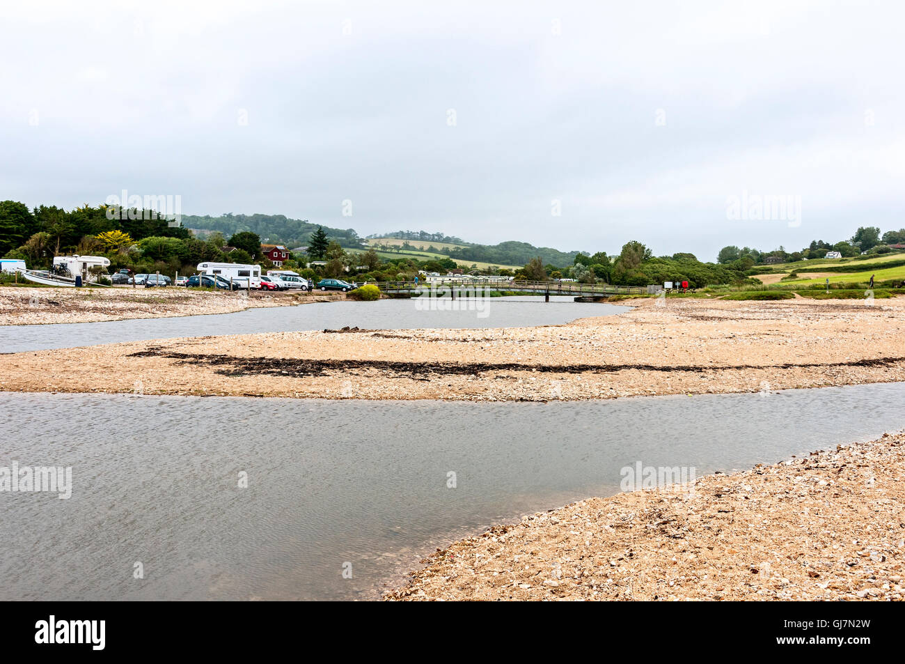 Charmouth beach is divided into two by the mouth of the River Char ...