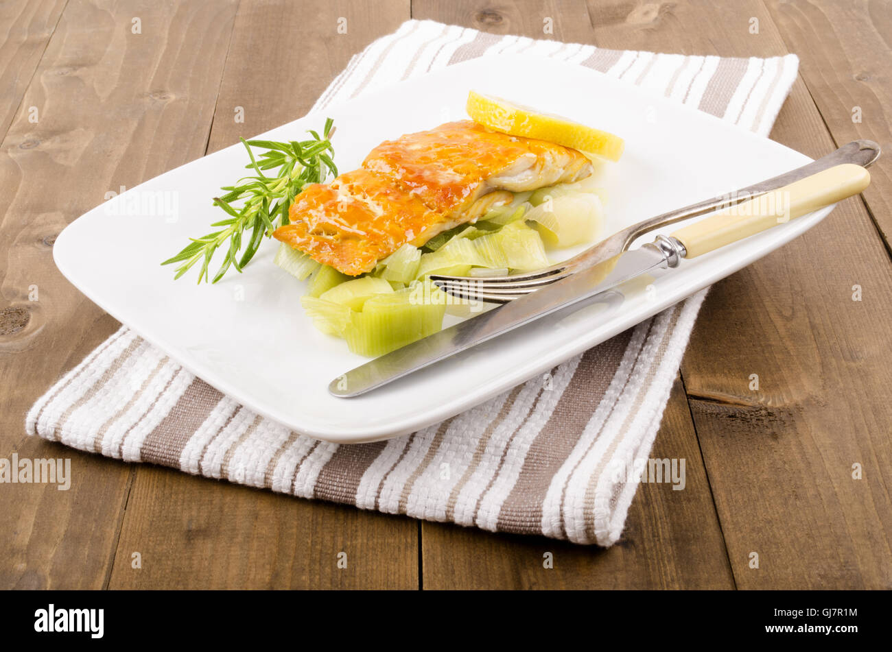 smoked, steamed haddock fillet with celery and rosemary on a plate ...