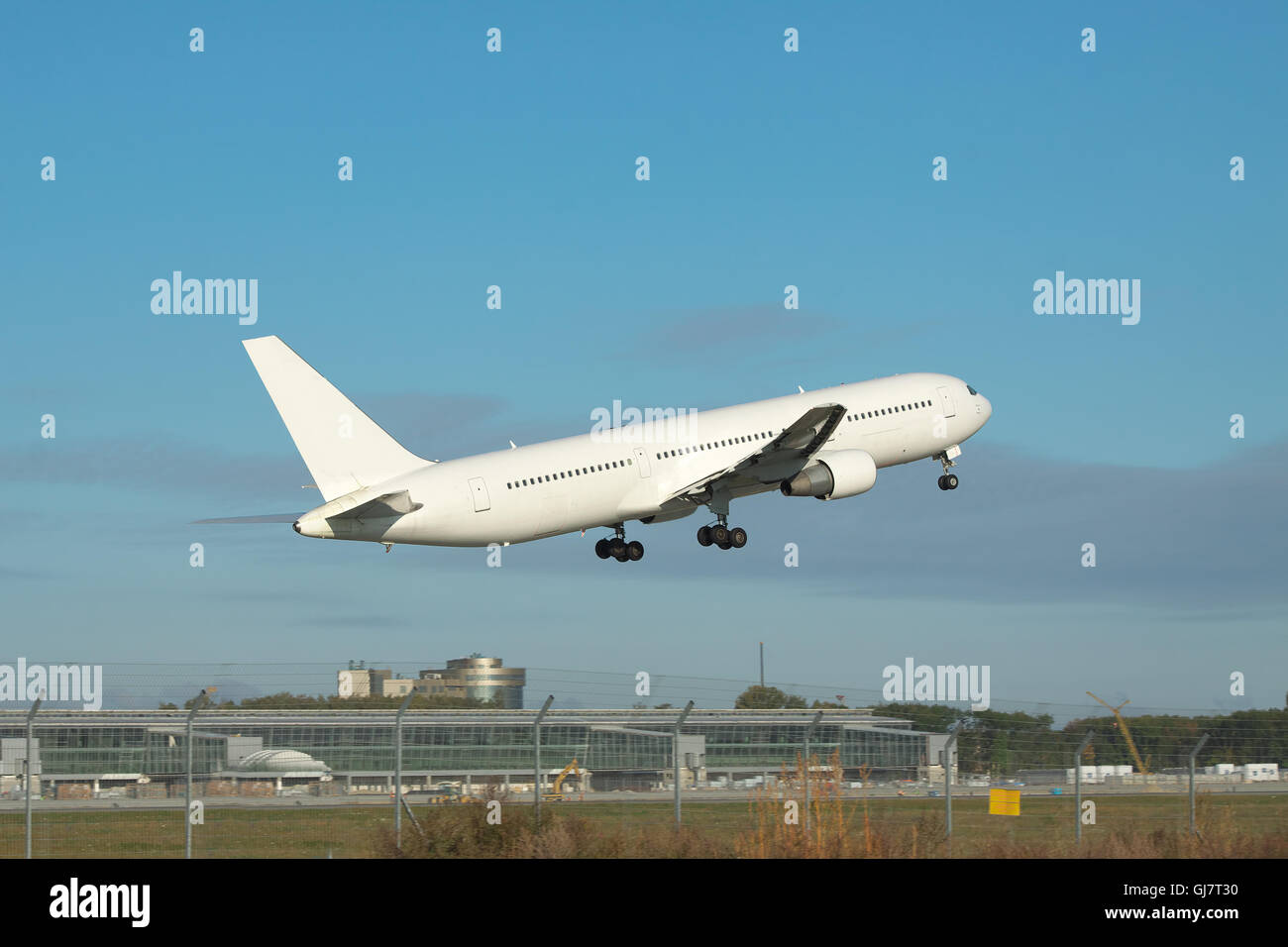 Passenger jet plane is taking off from the airport into clear sky Stock ...