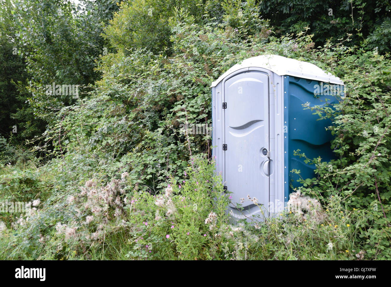 Plastic outside toilet abandoned in the bushes Stock Photo - Alamy