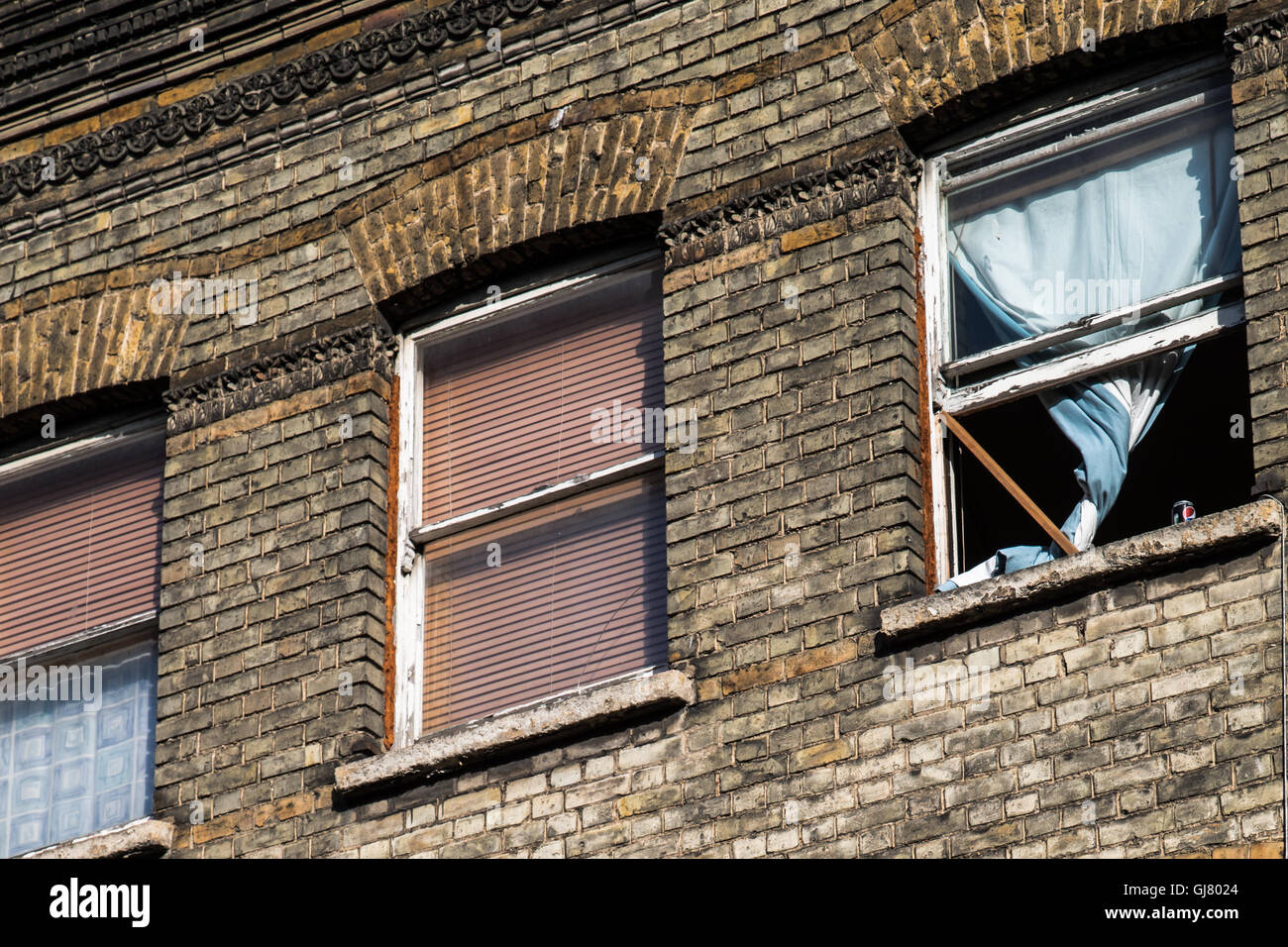 Row of Victorian Hatch Windows, London. One window is wedged open with ...