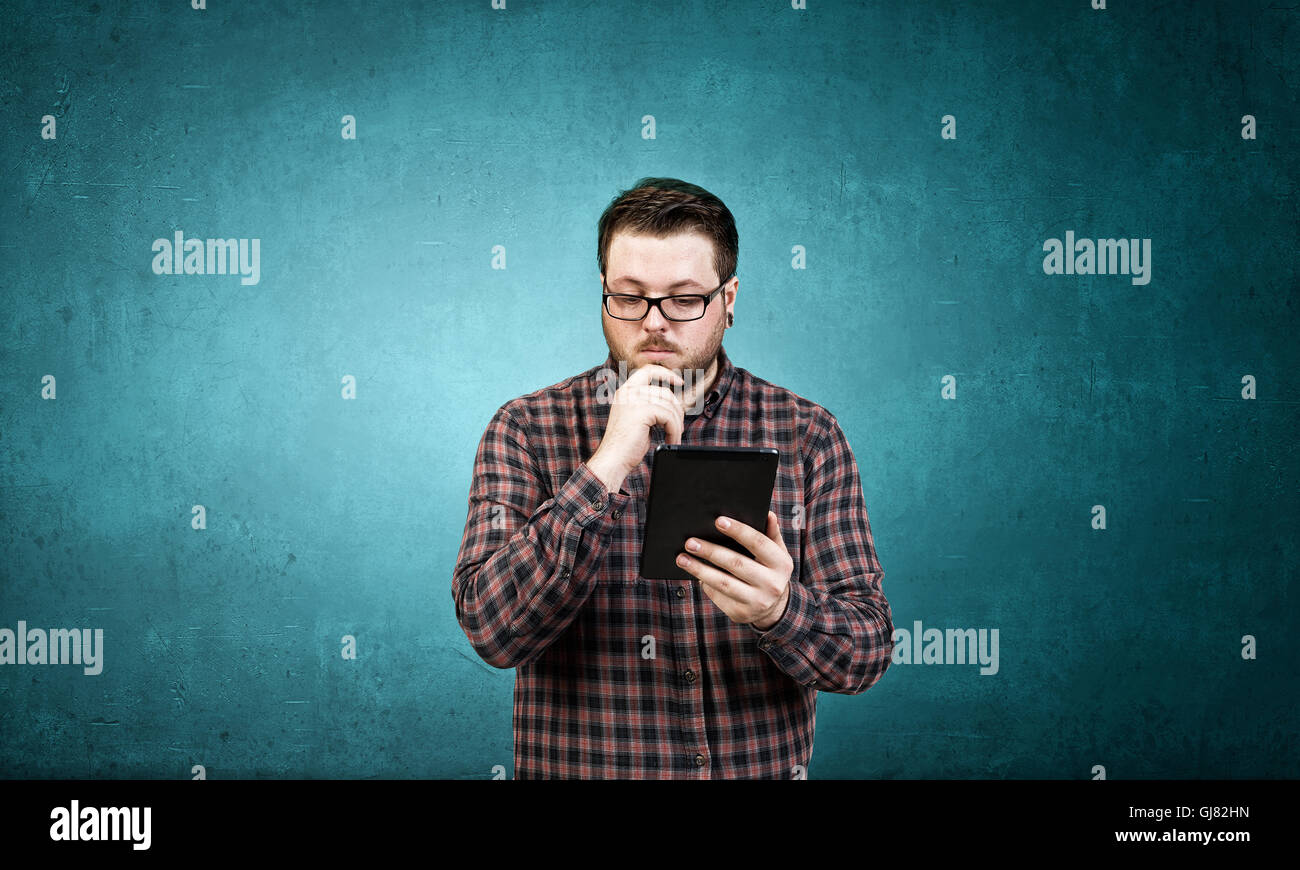 Hipster guy with tablet device . Mixed media Stock Photo - Alamy