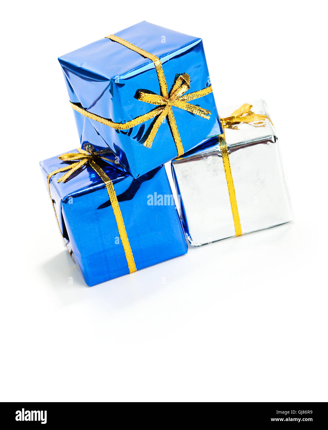 Series of miniature, colorful gift boxes, some on colored backgrounds ...